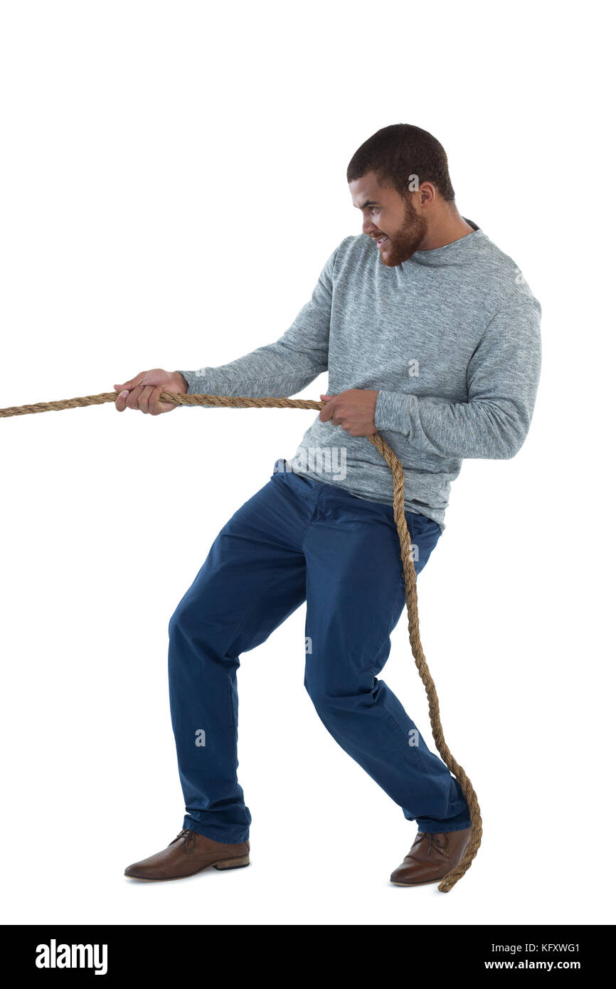 Young male executive pulling the rope against white background Stock ...