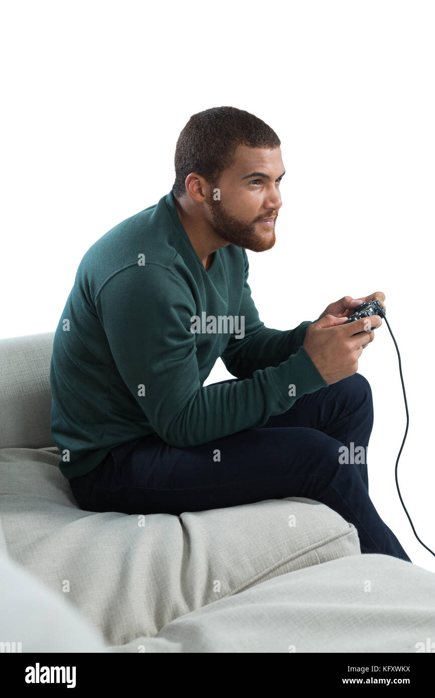 Side view of man playing video game against white background Stock ...