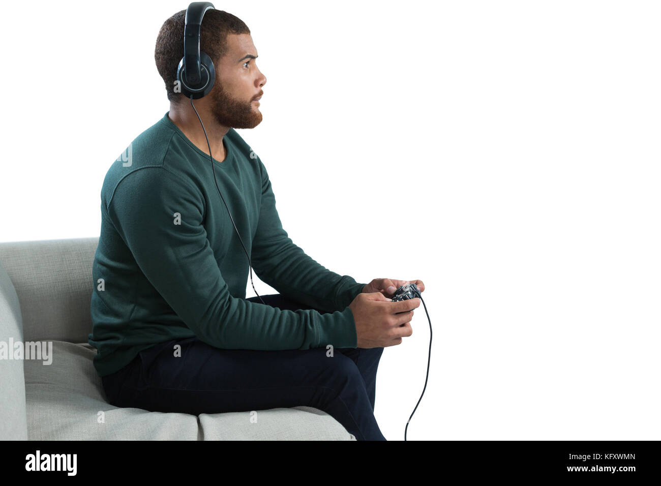 Side view of man playing video game against white background Stock ...