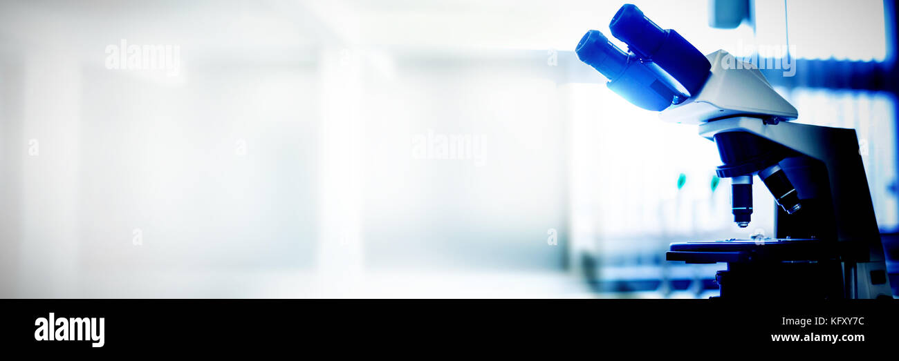 Microscope in laboratory against modern white room with window Stock ...