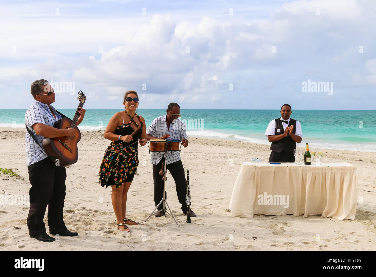 Trio ensemble of musicians consisting of two men and one woman ...