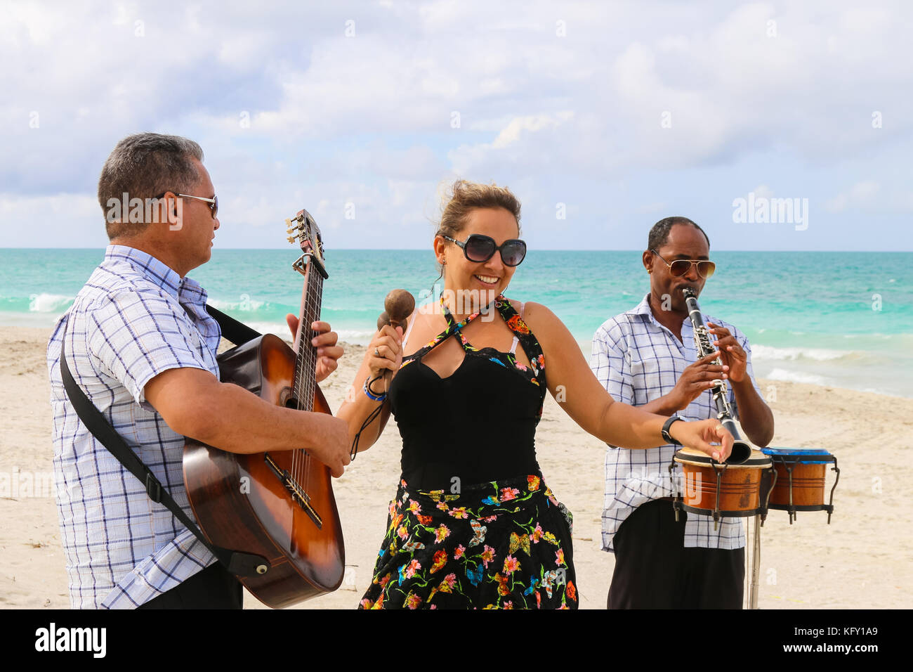 Trio ensemble of musicians consisting of two men and one woman ...