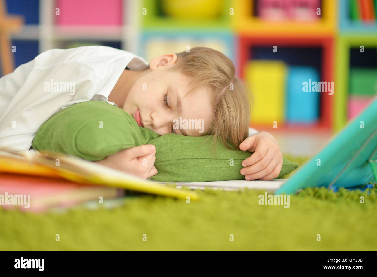 Tired cute boy sleeping Stock Photo - Alamy