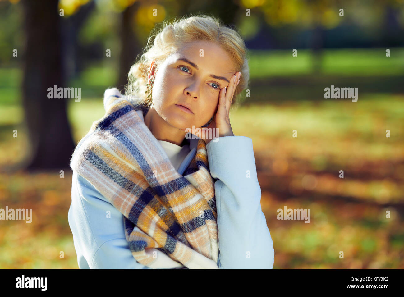 Woman looking concerned outdoors Stock Photo - Alamy