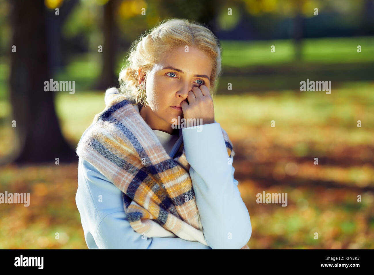 Woman looking concerned outdoors Stock Photo - Alamy
