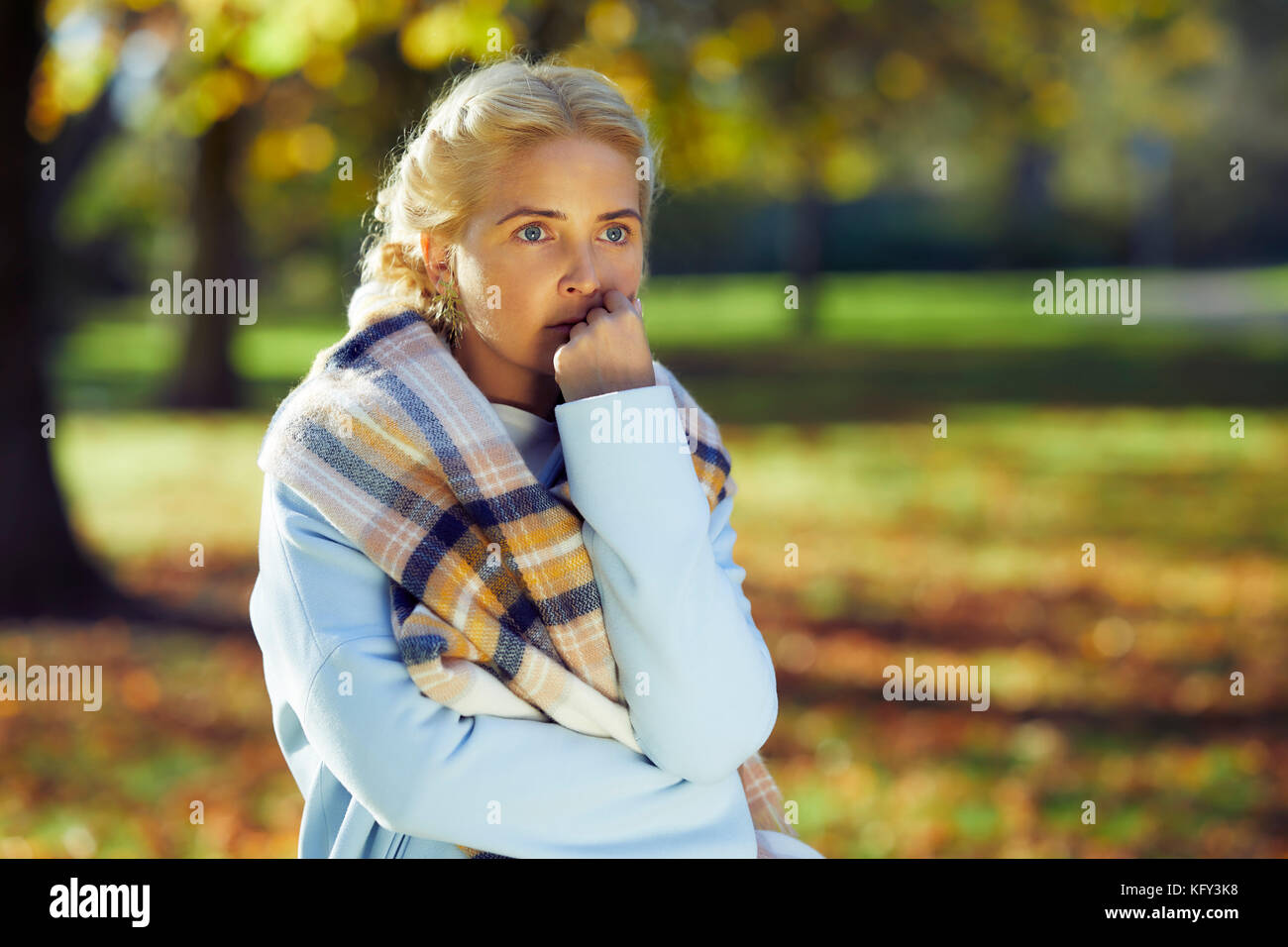 Woman looking concerned outdoors Stock Photo - Alamy