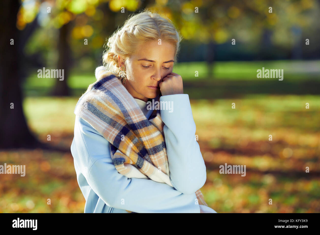 Woman looking concerned outdoors Stock Photo - Alamy