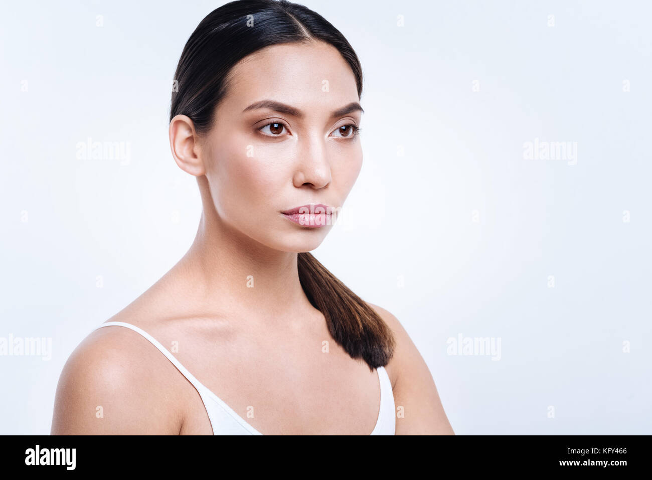 Dark-haired woman with swarthy complexion posing half-turned Stock ...