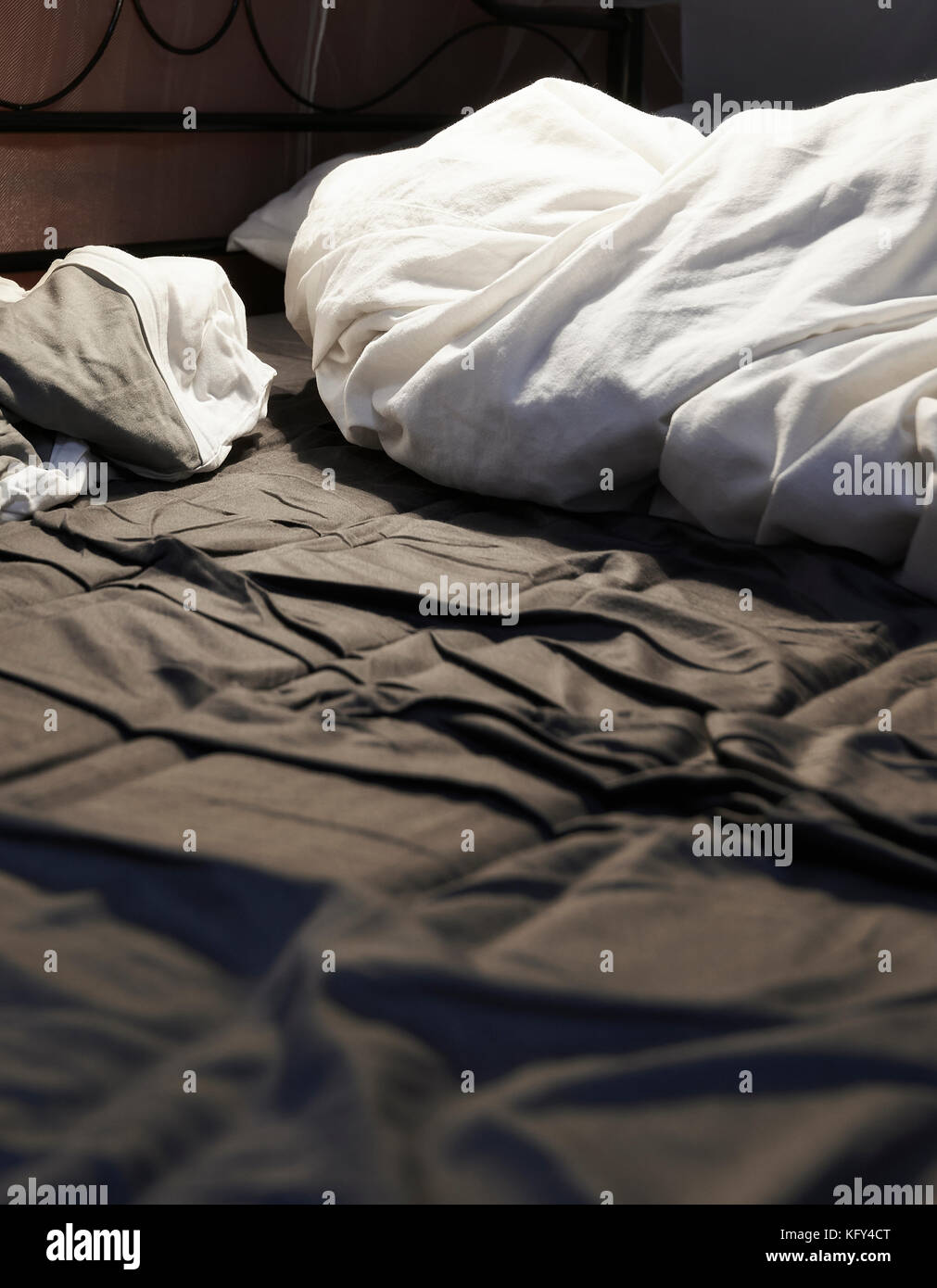 Disheveled sheets and pillows of an unmade bed,led light and Mosquito ...