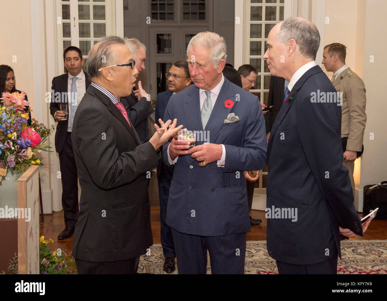 The Prince of Wales (centre) chats with an unnamed guest and British ...