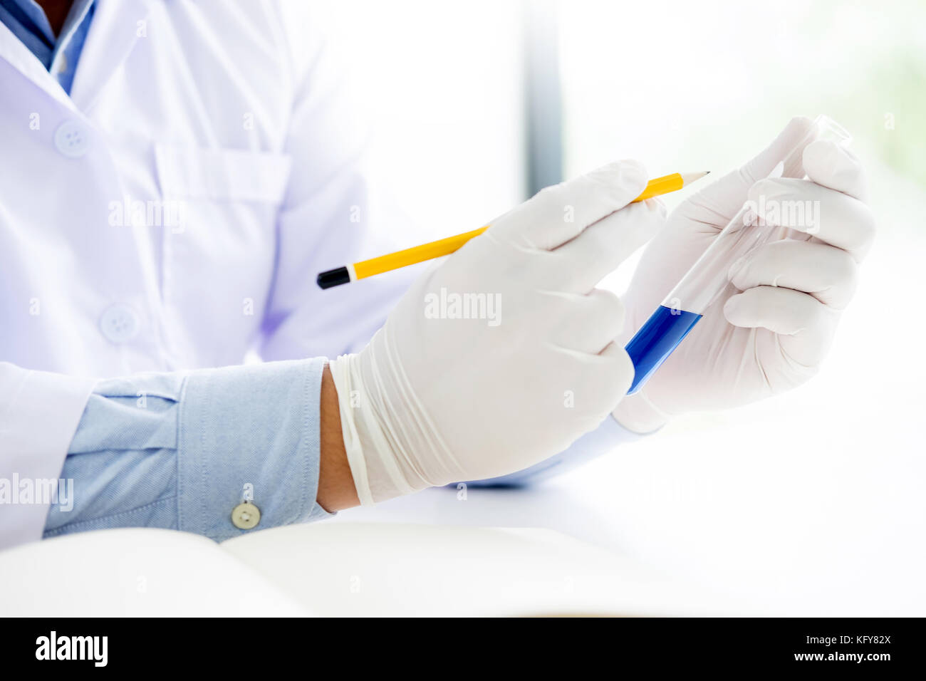 Female laboratory assistant holding microscope hi-res stock photography ...