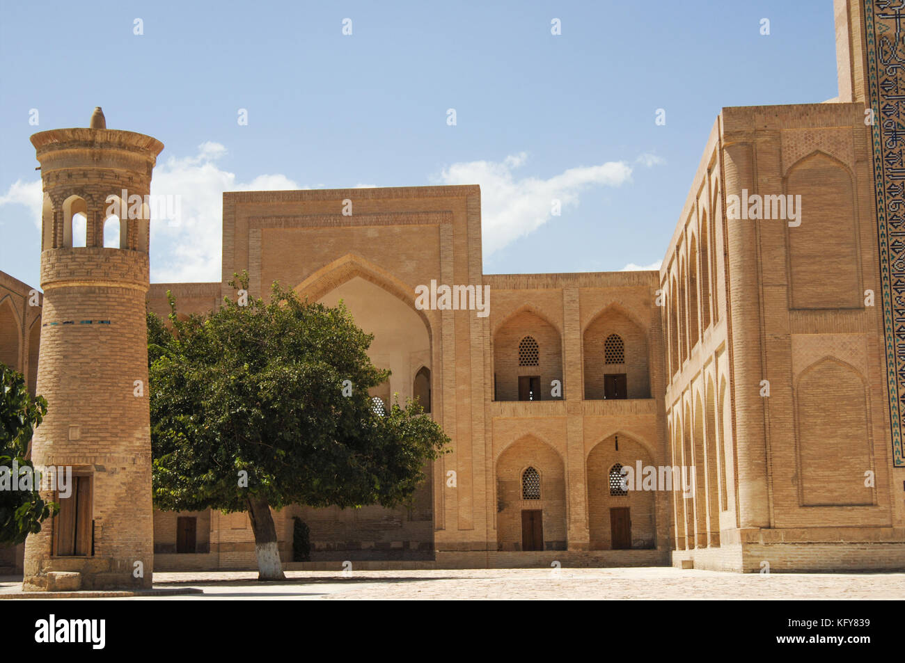 Multi-storey building with a tower and tree. the ancient buildings of ...