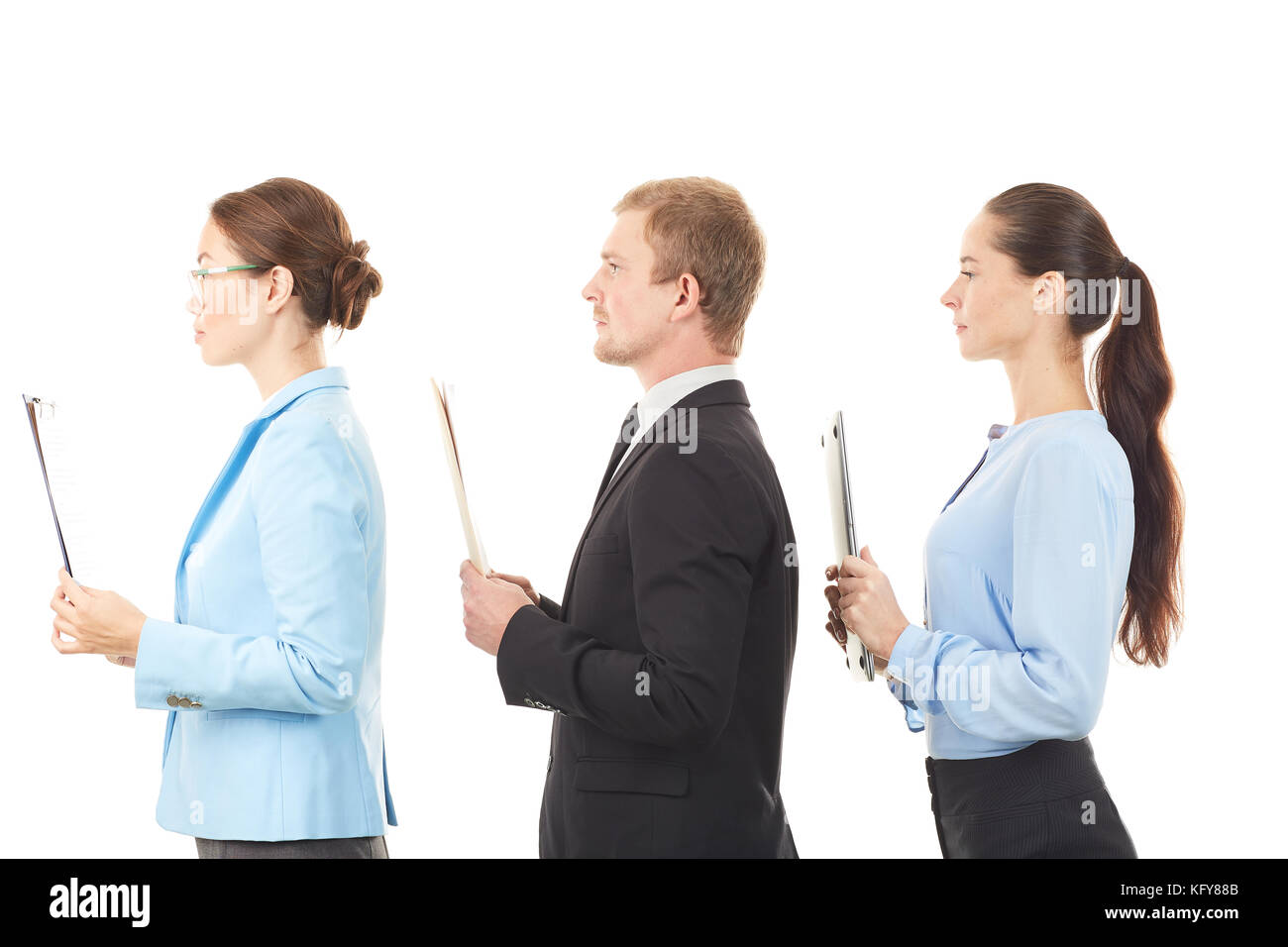 Portrait of three office workers standing one after another on white ...