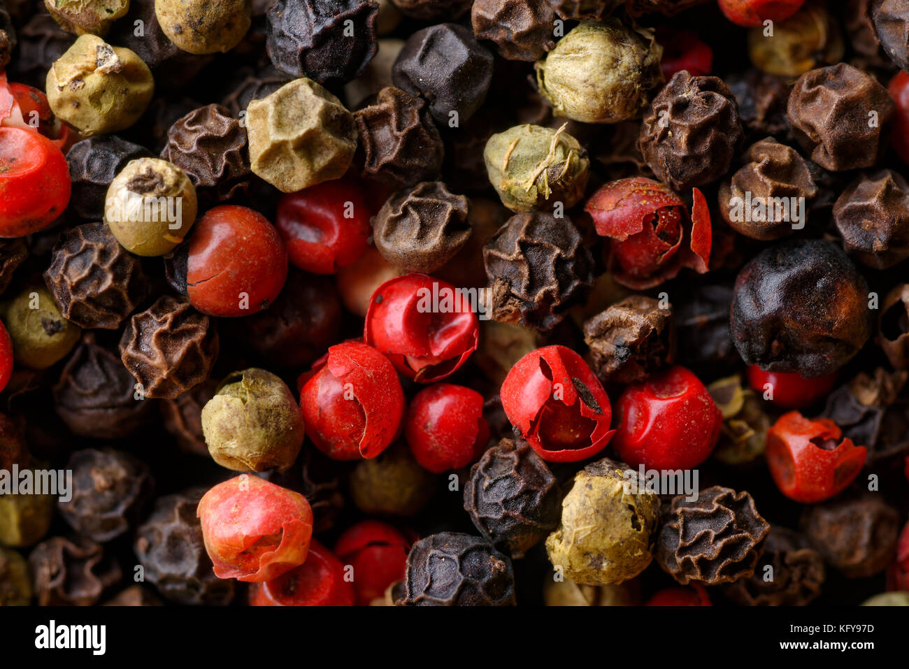 Backgrounds and textures: a lot of multicolored pepper corns, close-up ...