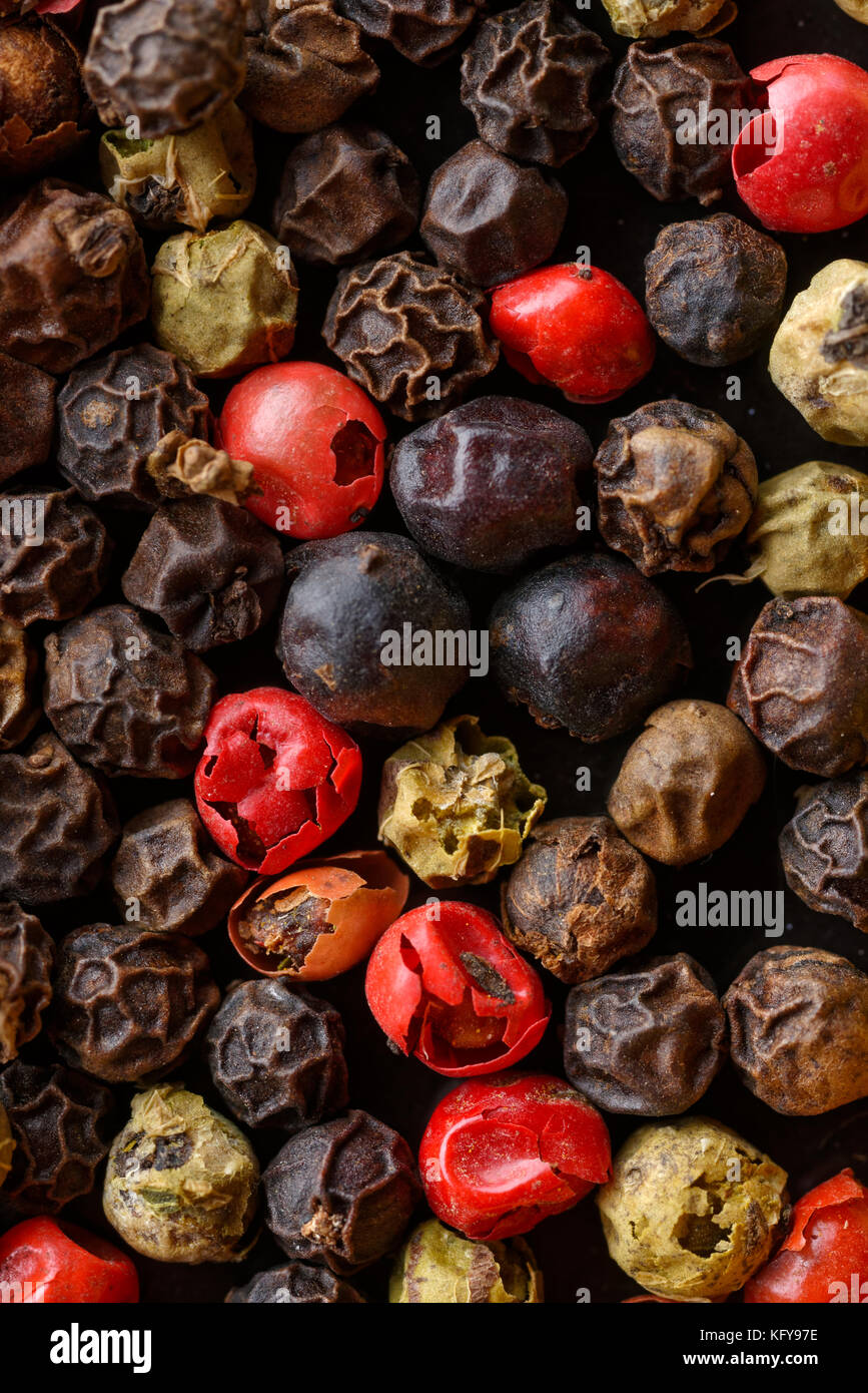 Backgrounds and textures: a lot of multicolored pepper corns, close-up ...