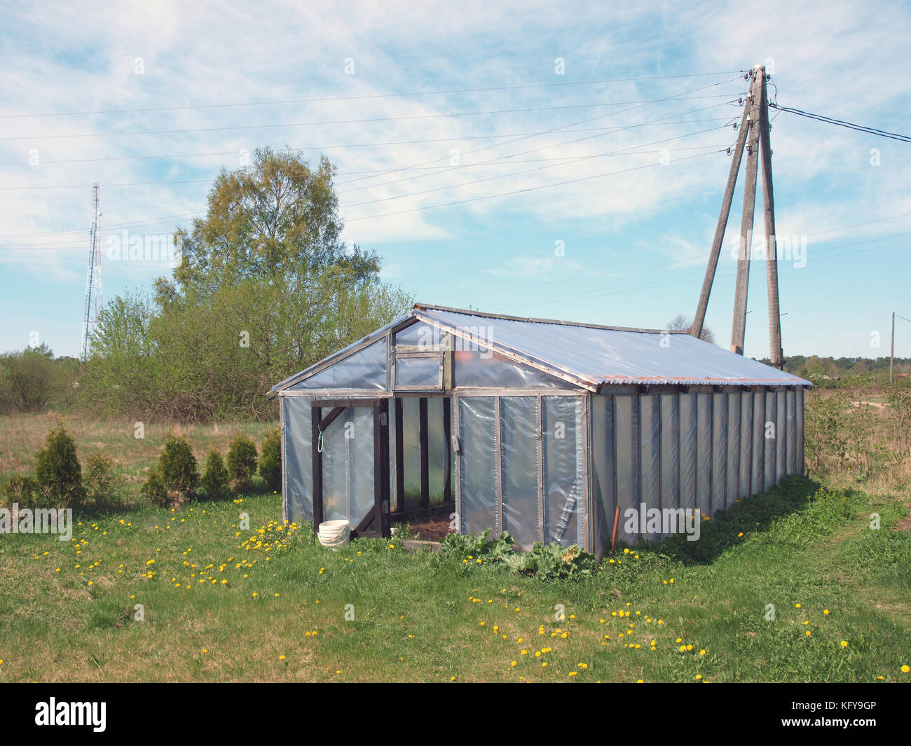 Homemade small plastic greenhouse on country farm Stock Photo - Alamy