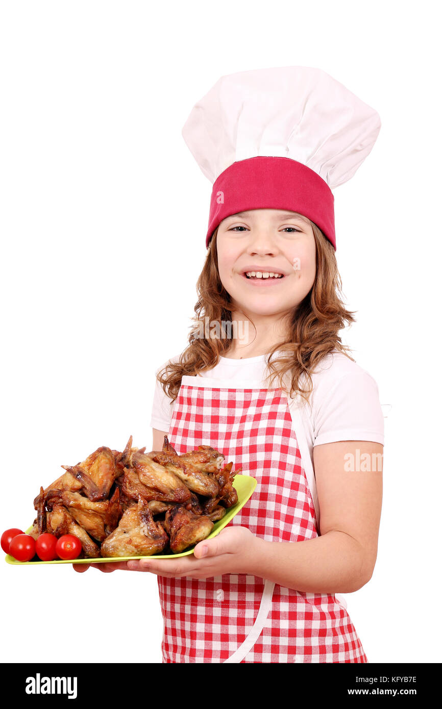 Happy little girl cook with roasted chicken wings Stock Photo - Alamy