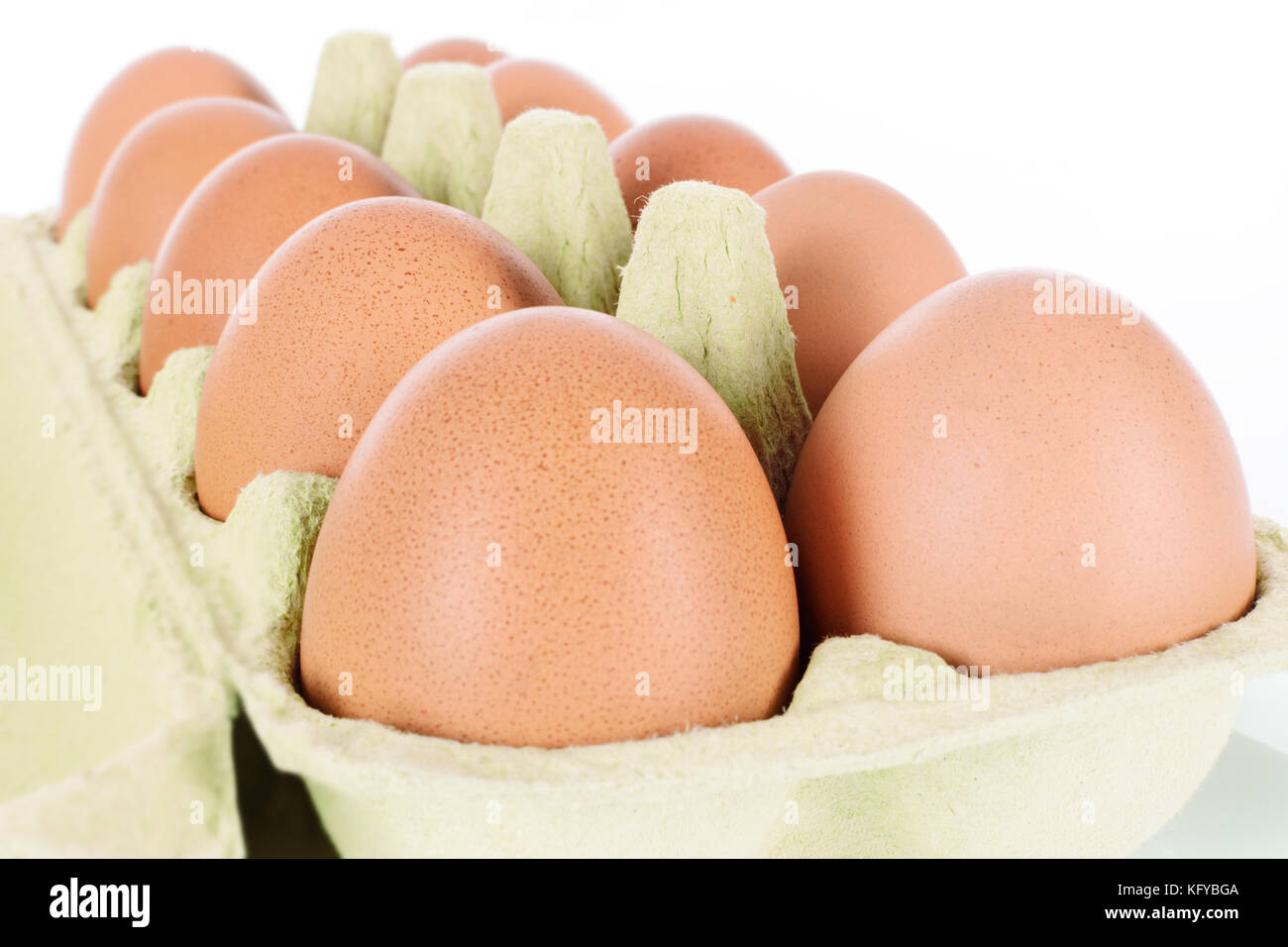 Ten eggs in a container in close up and isolated on white background ...