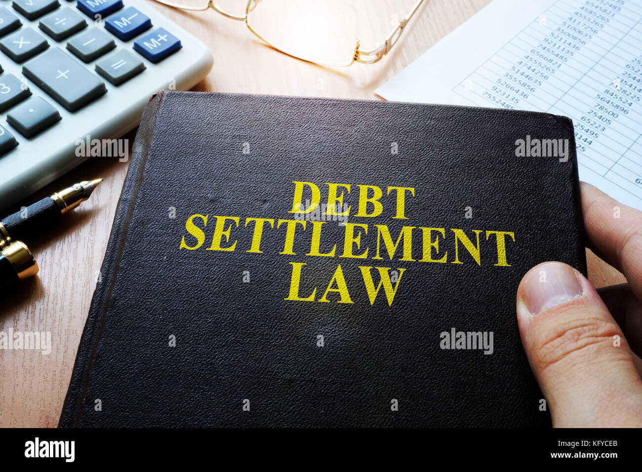 Debt Settlement Law on a table Stock Photo - Alamy