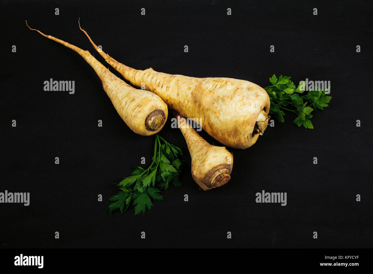 fresh parsnip on black background Stock Photo - Alamy