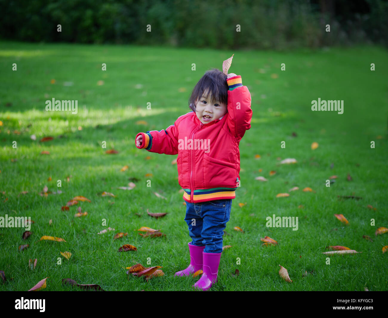 Baby girl playing at Autumn outdoor park Stock Photo - Alamy