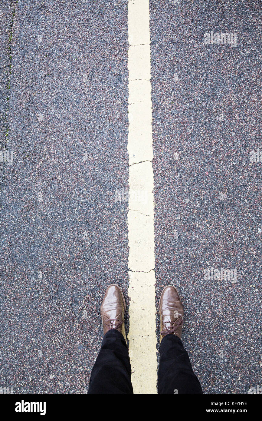 Casual woman shoes standing over the white line that separate left and ...