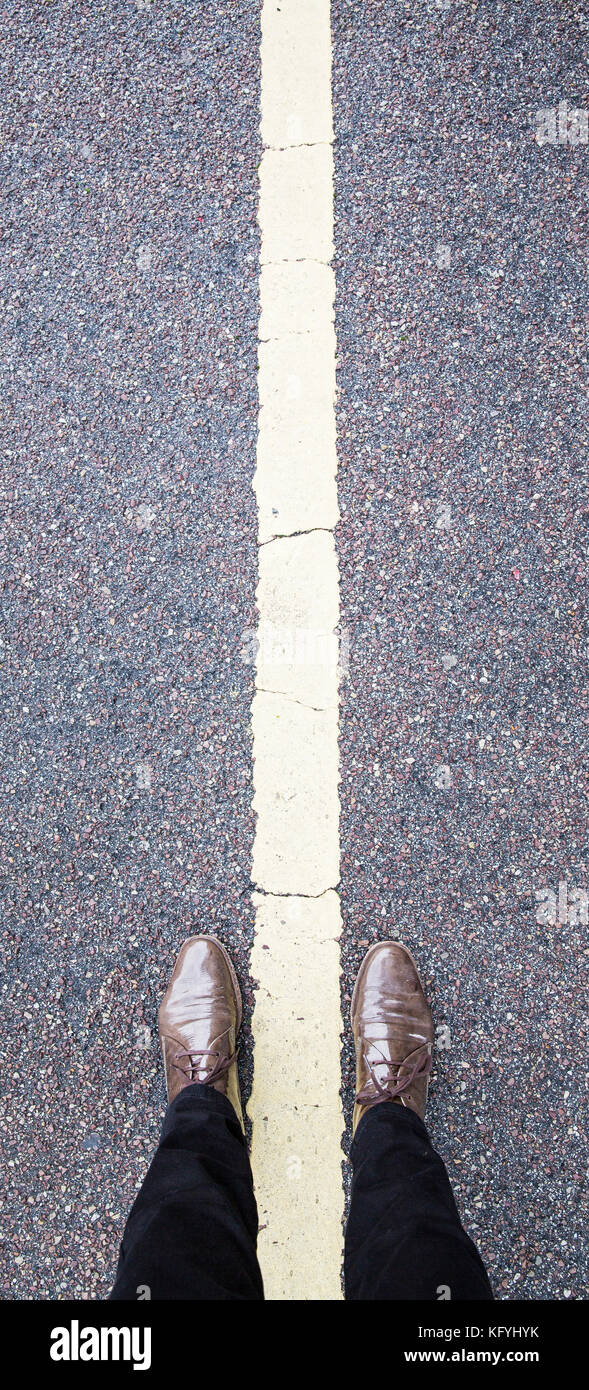 Casual woman shoes standing over the white line that separate left and ...