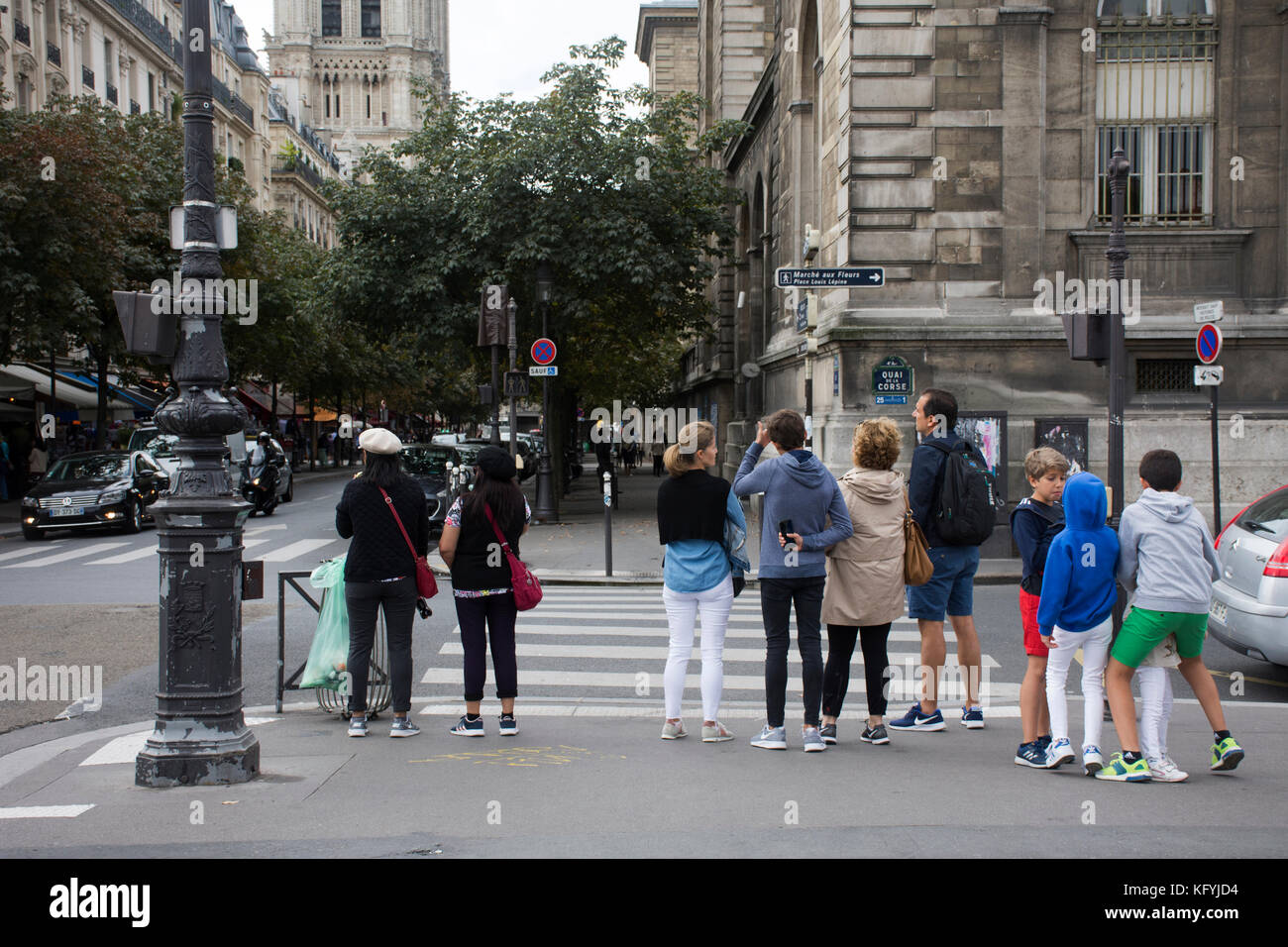 French people and foreigner travelers waiting for crossing traffic road ...