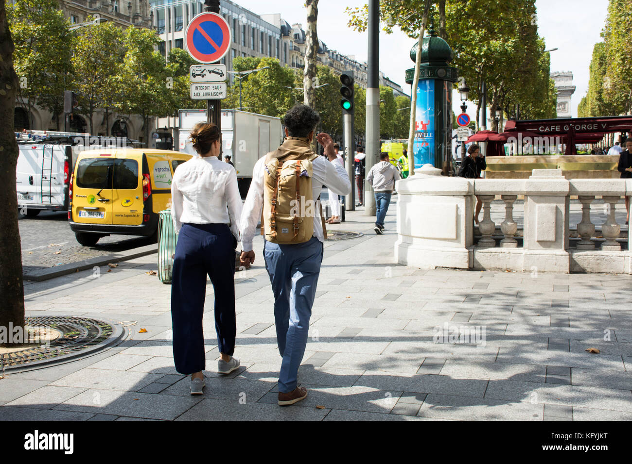French people boyfriend and girlfriend walking hand in hand on walkway ...