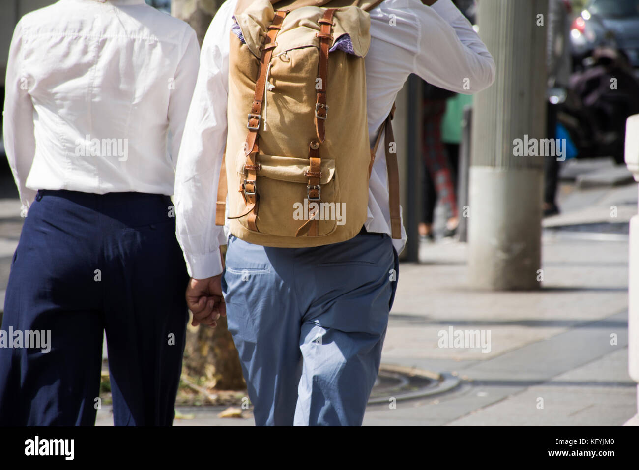 French people boyfriend and girlfriend walking hand in hand on walkway ...
