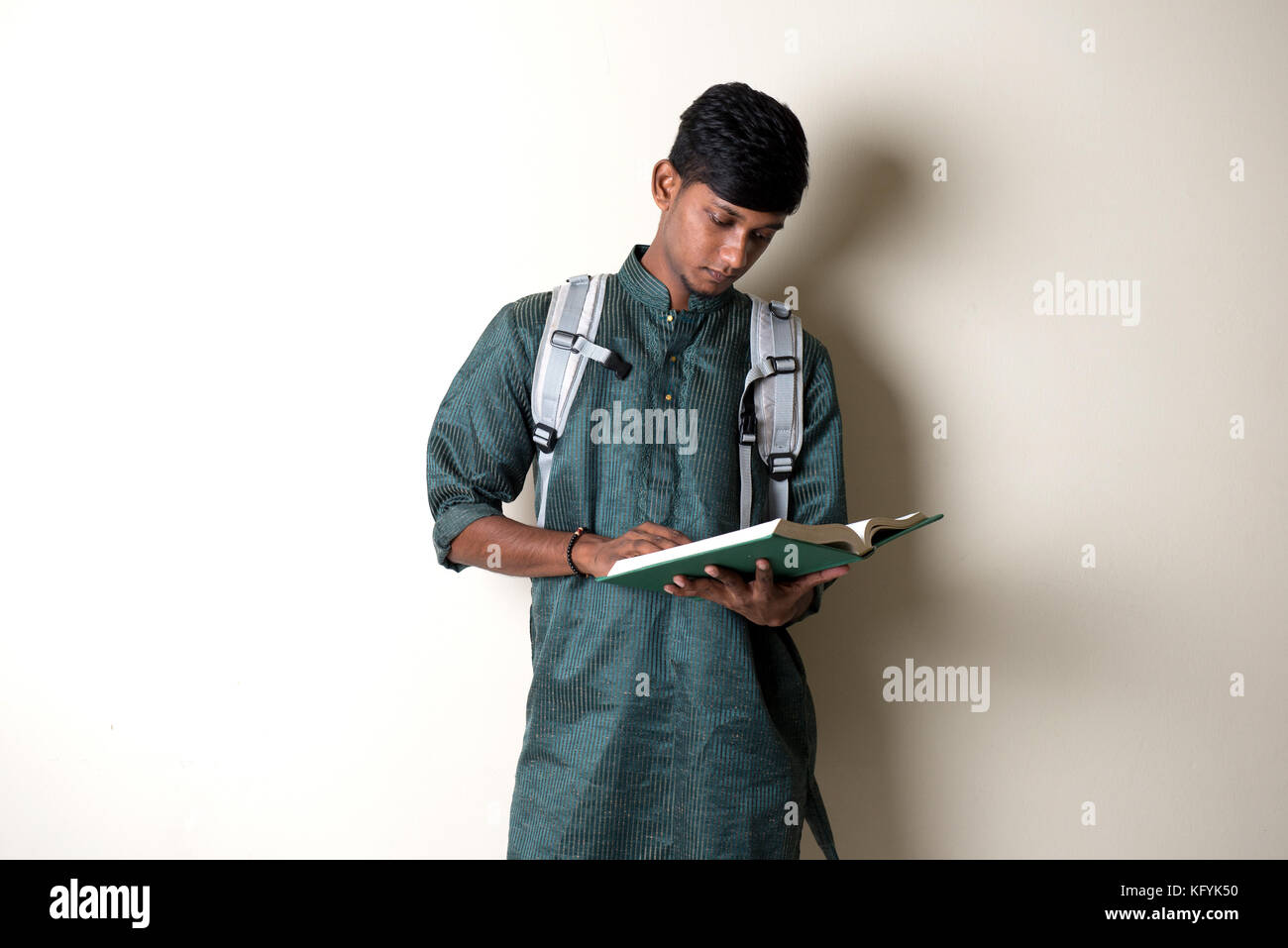 teenage indian male in traditional dress reading books Stock Photo - Alamy