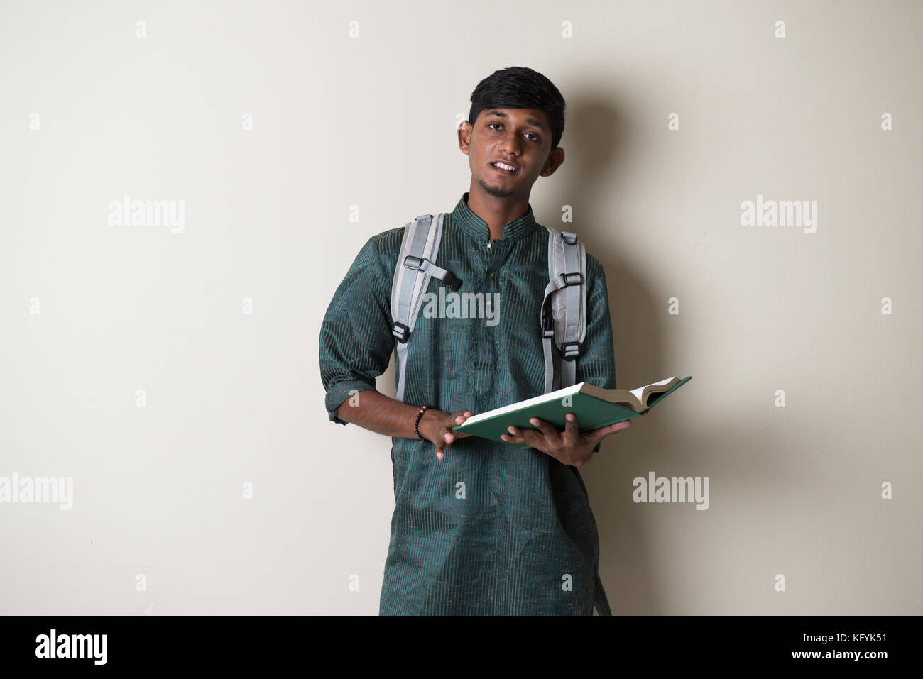 teenage indian male in traditional dress reading books Stock Photo - Alamy