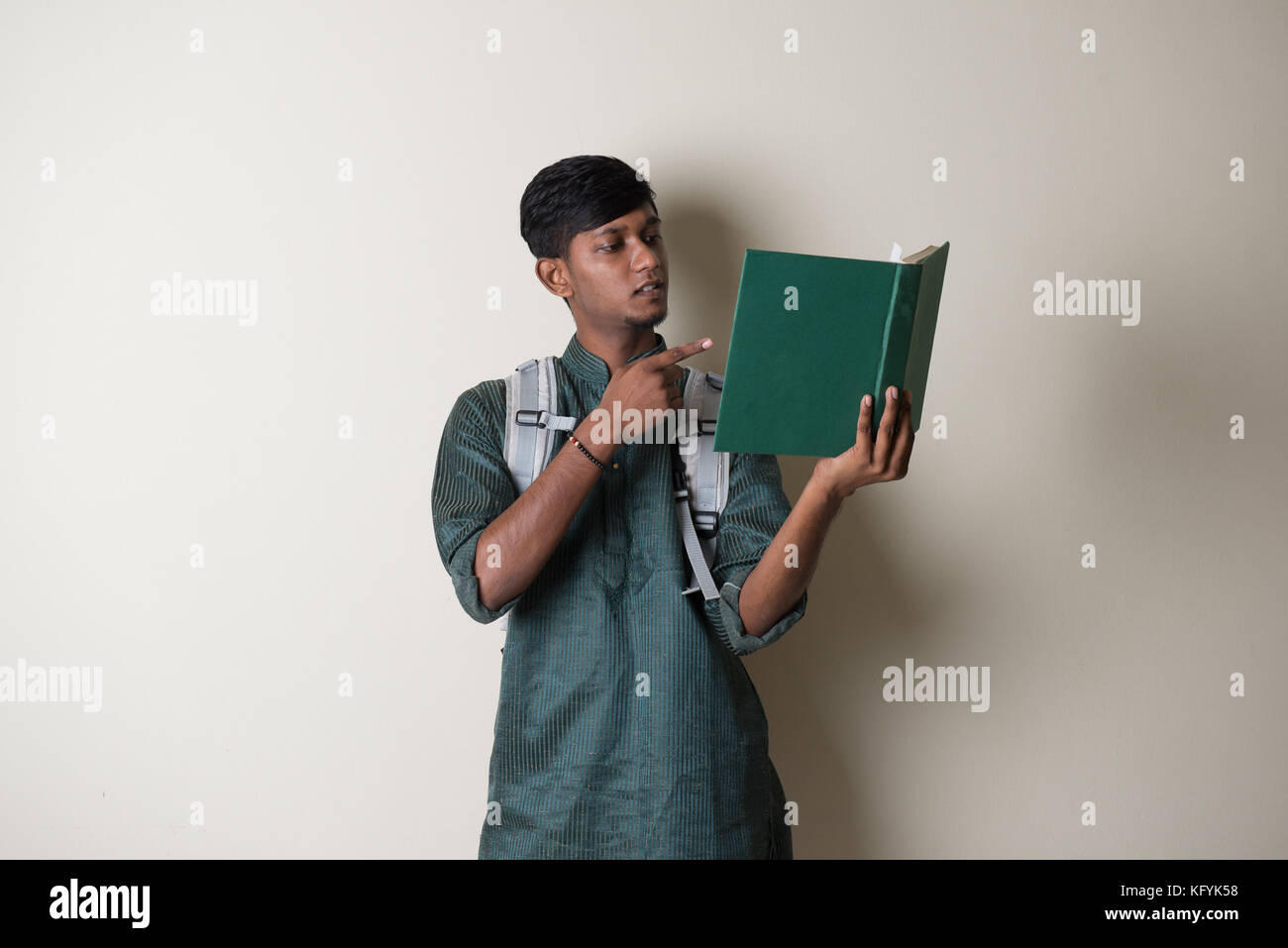 teenage indian male in traditional dress reading books Stock Photo - Alamy