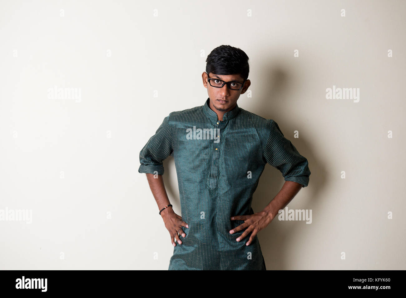 teenage indian male in traditional dress looking angry and frustrated ...