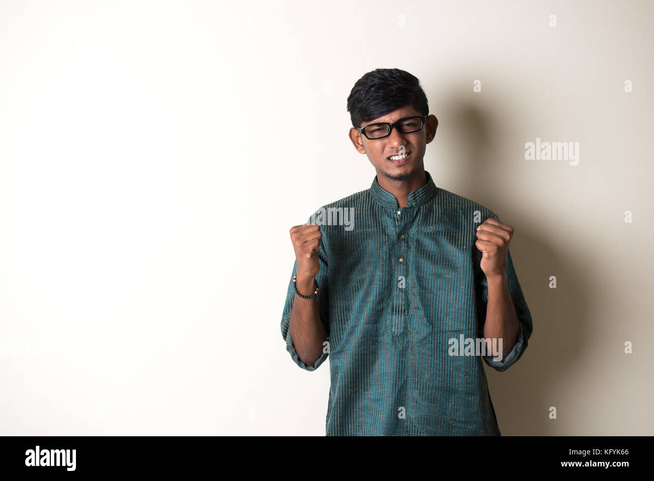 teenage indian male in traditional dress looking angry and frustrated ...