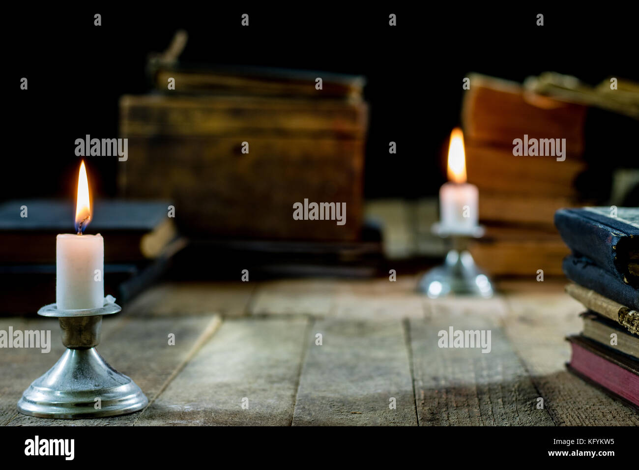 Old books and candles on a wooden table. Old room, reading room. Black ...