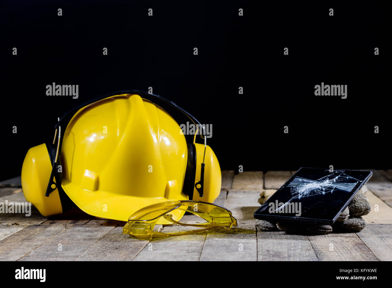 helmet, hearing protection, tools, workshop table. Safety equipment and ...