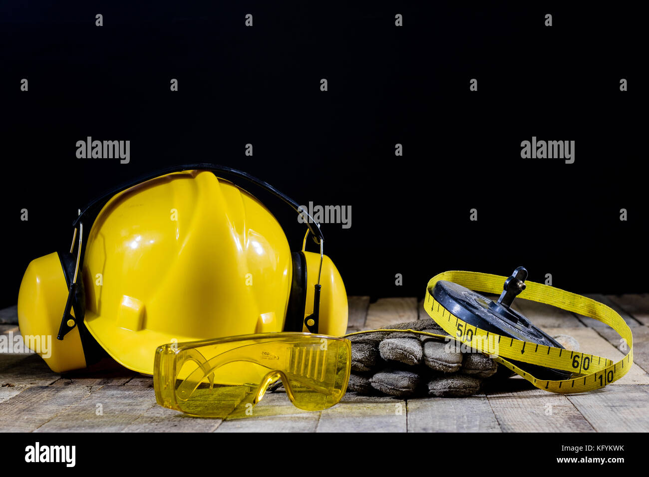 helmet, hearing protection, tools, workshop table. Safety equipment and ...