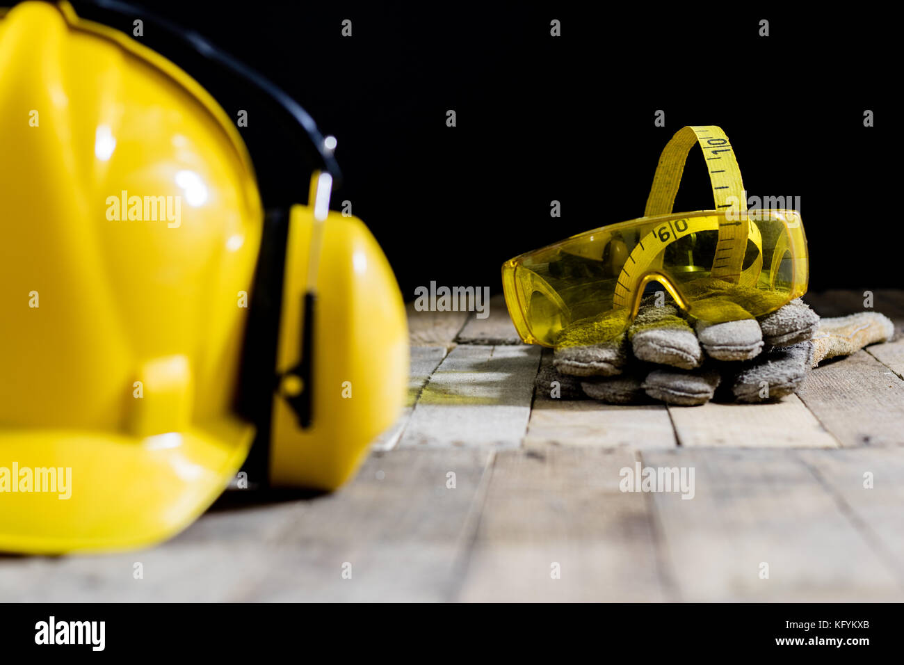 helmet, hearing protection, tools, workshop table. Safety equipment and ...