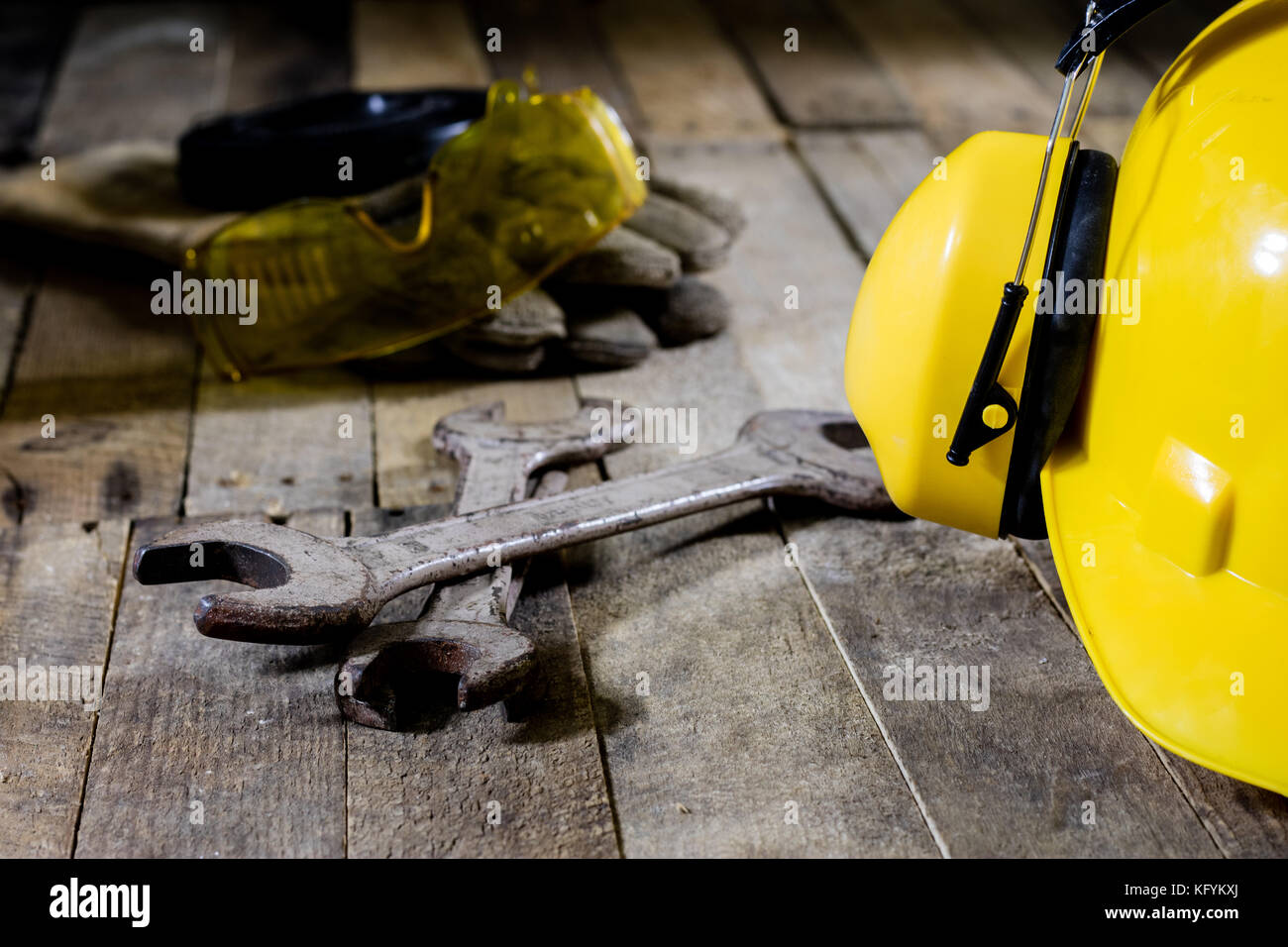 helmet, hearing protection, tools, workshop table. Safety equipment and ...
