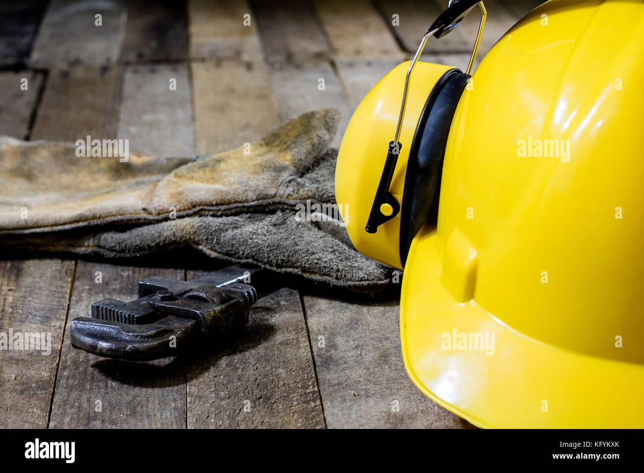 helmet, hearing protection, tools, workshop table. Safety equipment and ...