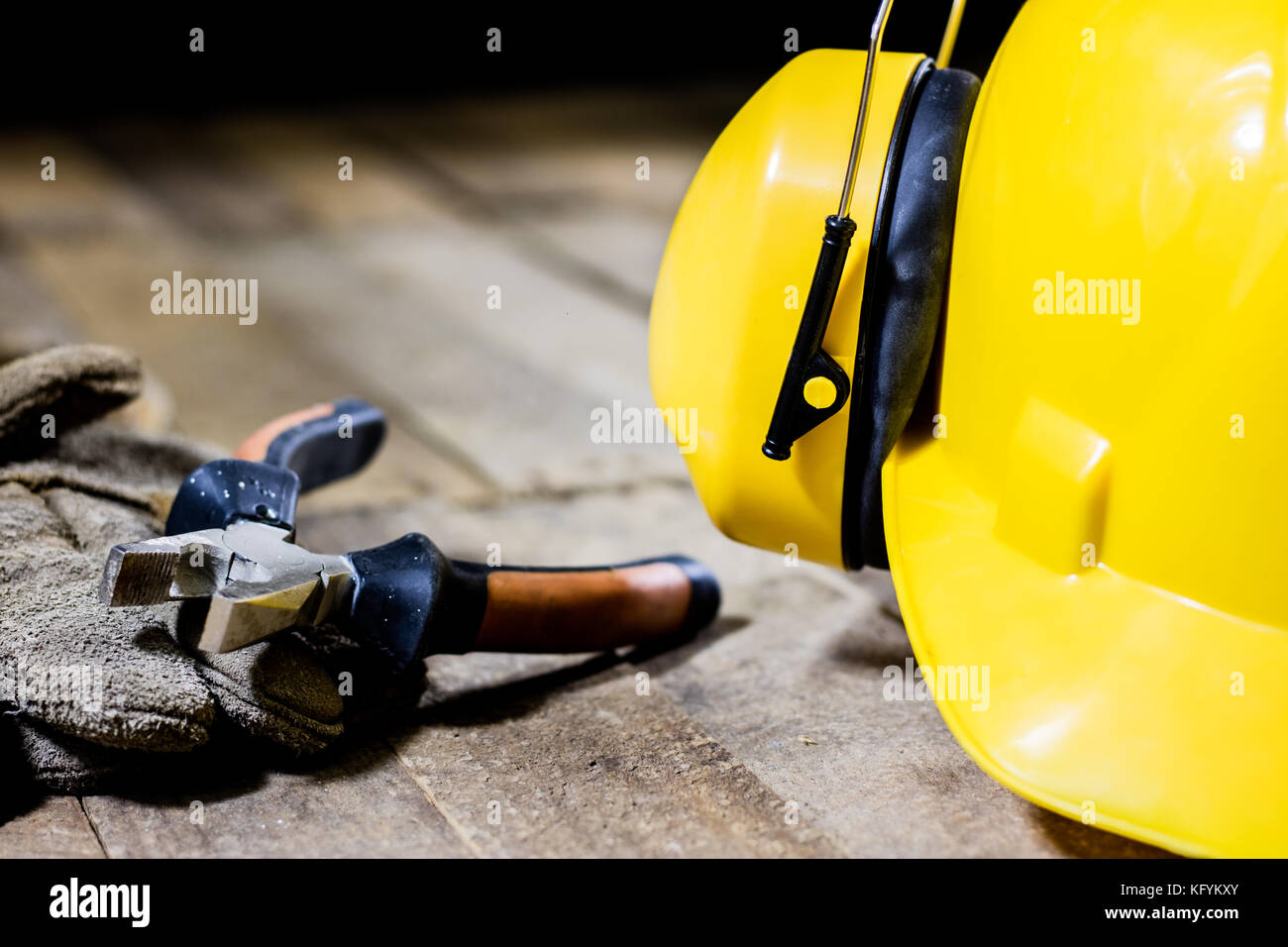 helmet, hearing protection, tools, workshop table. Safety equipment and ...