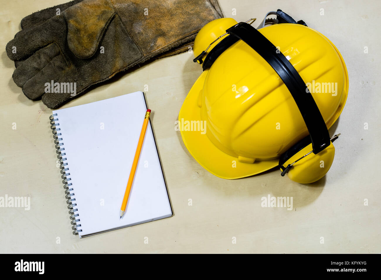 helmet, hearing protection, tools, workshop table. Safety equipment and ...