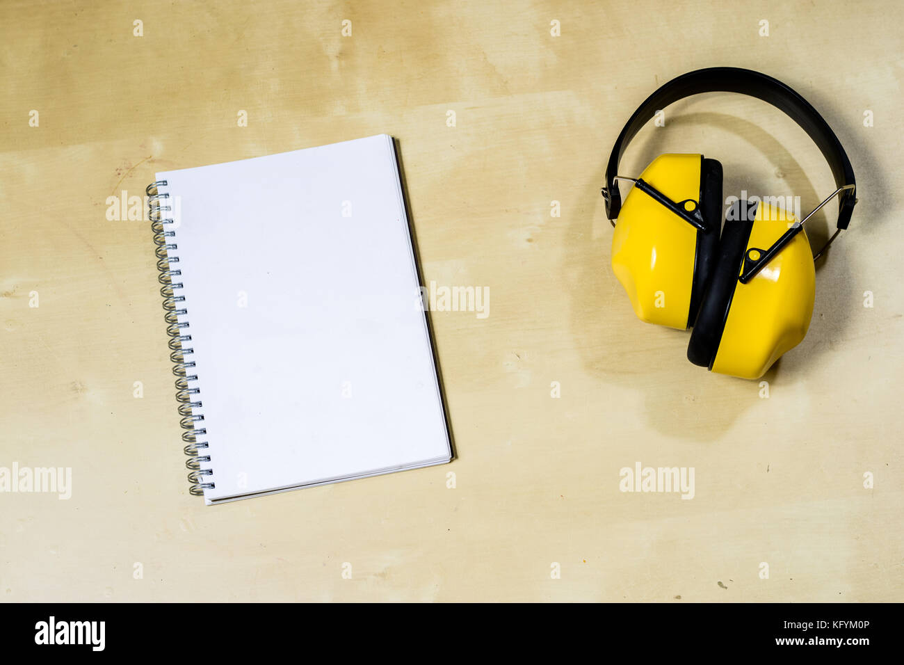 helmet, hearing protection, tools, workshop table. Safety equipment and ...