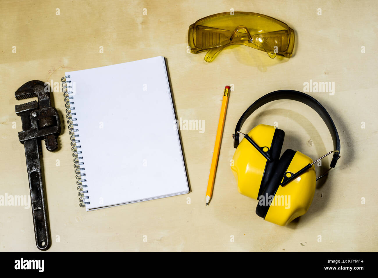 helmet, hearing protection, tools, workshop table. Safety equipment and ...