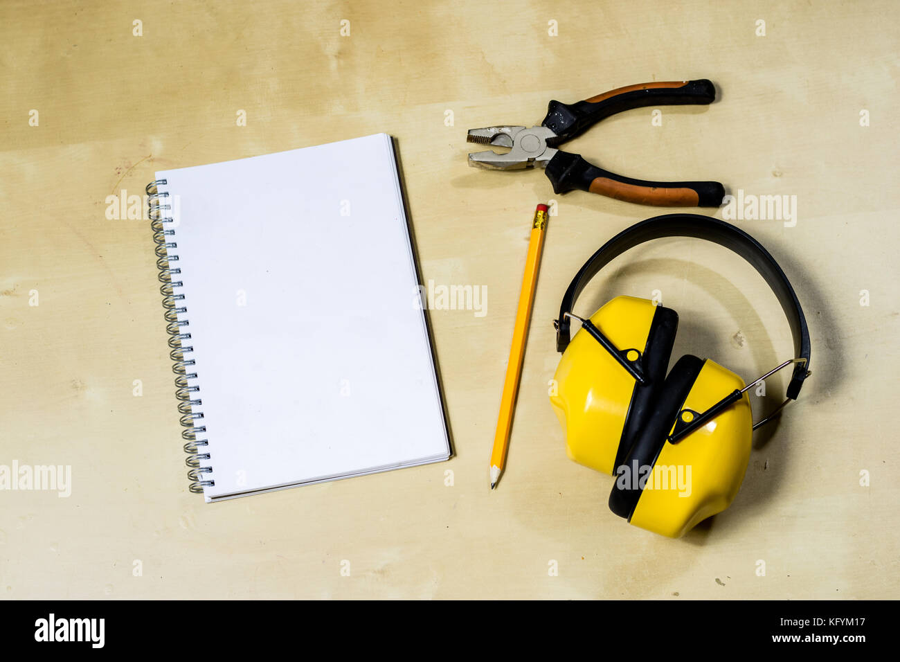 helmet, hearing protection, tools, workshop table. Safety equipment and ...