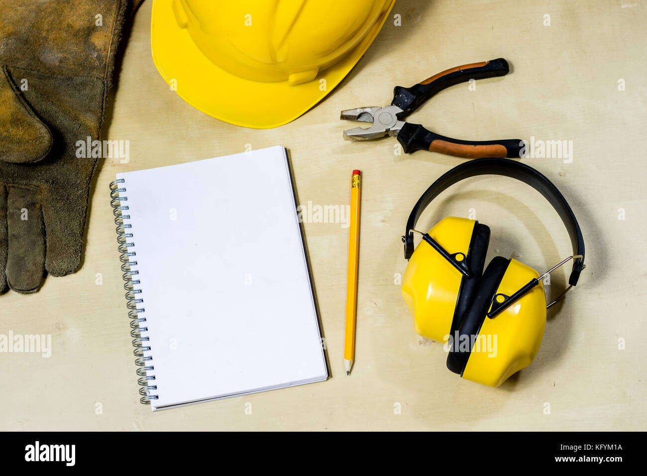 helmet, hearing protection, tools, workshop table. Safety equipment and ...