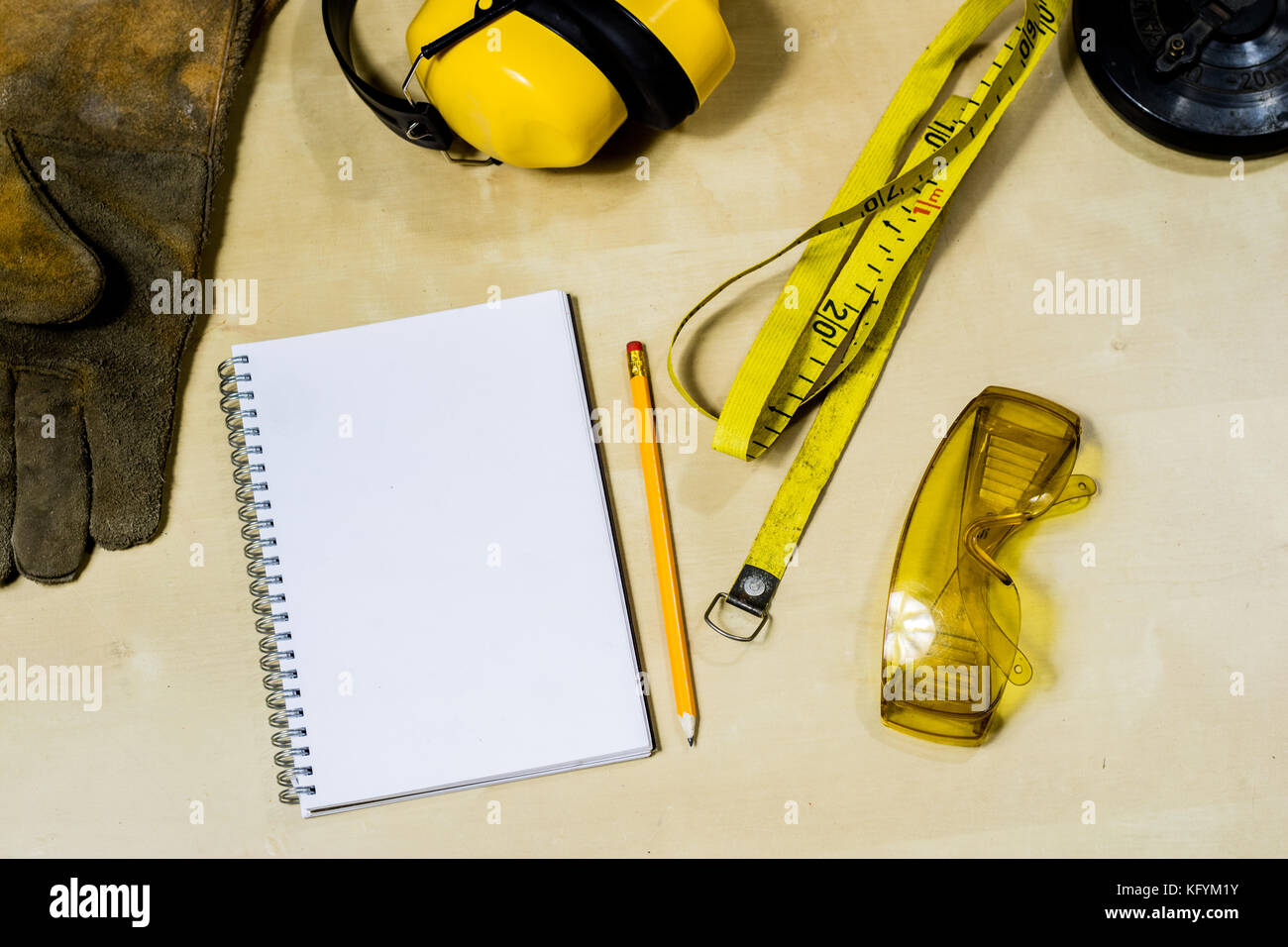 helmet, hearing protection, tools, workshop table. Safety equipment and ...