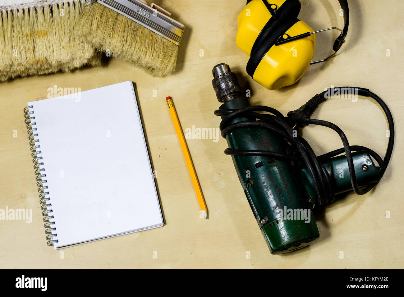 helmet, hearing protection, tools, workshop table. Safety equipment and ...