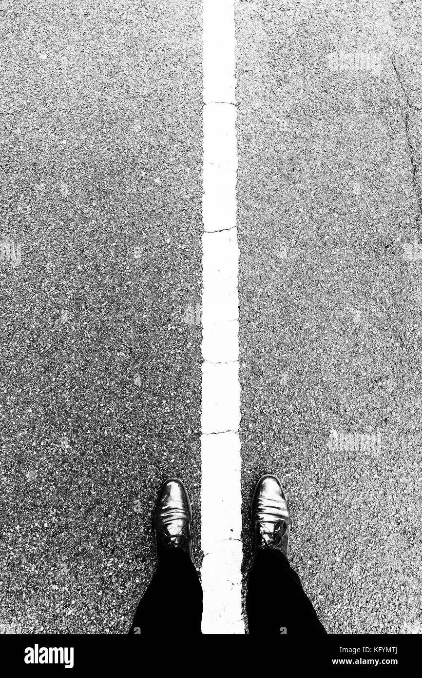 Casual woman shoes standing over the white line that separate left and ...